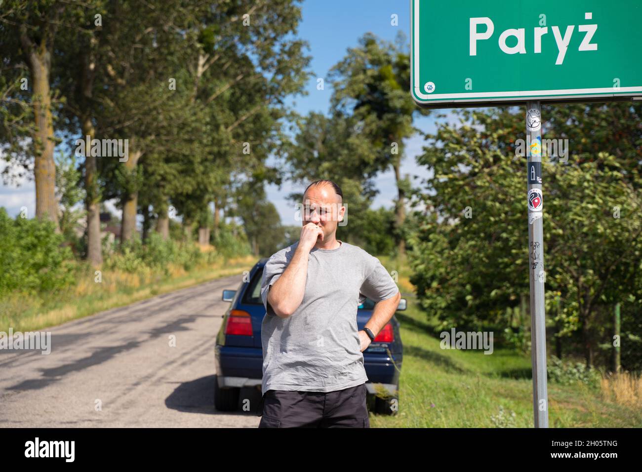 A lost driver is standing behind the car Stock Photo - Alamy