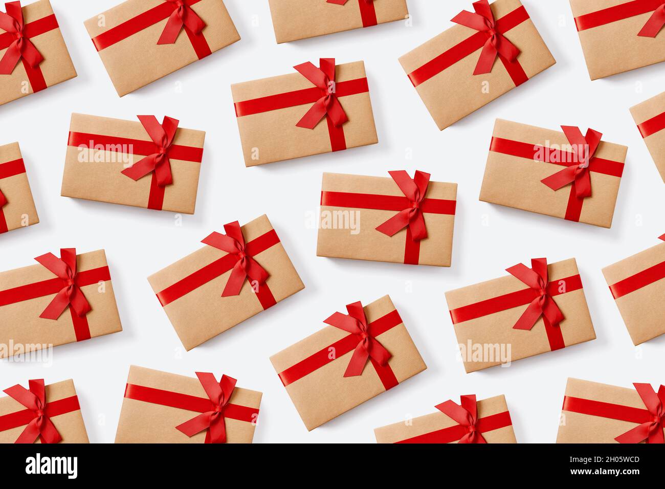 Overhead view of repetitive pattern of holiday gift boxes wrapped in ...