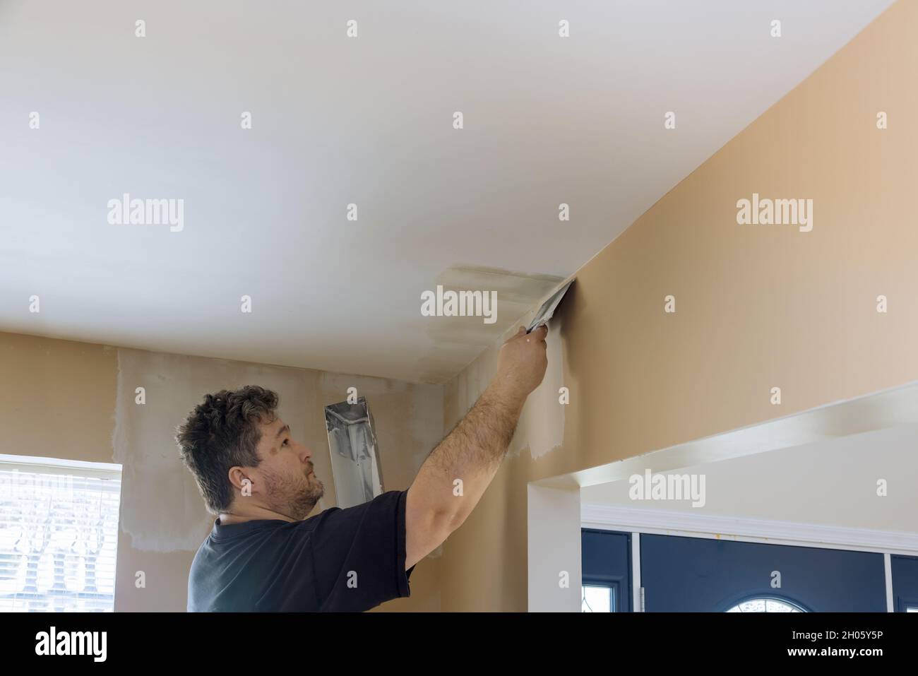 Plastering wall coating putty plaster on the wall on home interior ...