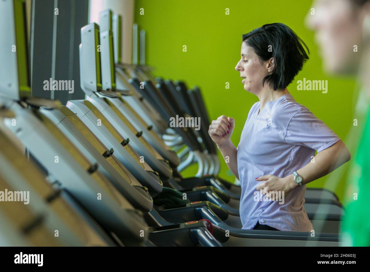 Runners using a running machines in a Leisure Centre Stock Photo - Alamy