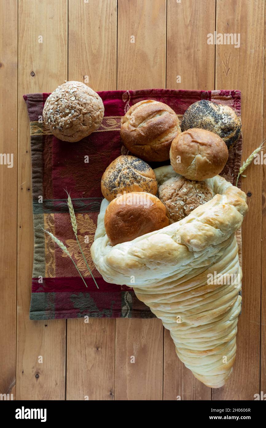 Vertical view of a cornucopia made of bread with rolls and buns ...