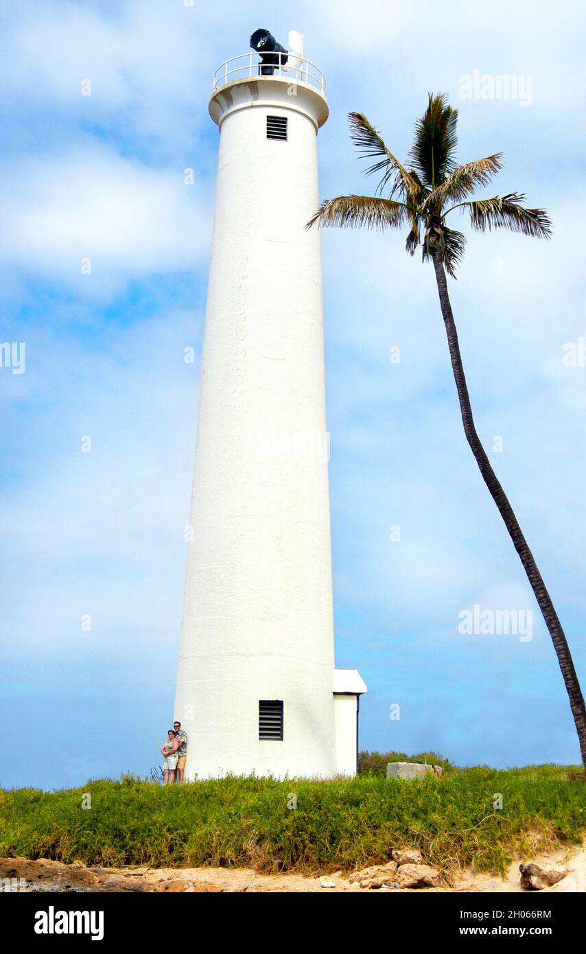 Couple stands at the base of Barber's Point Lighthouse to show ...