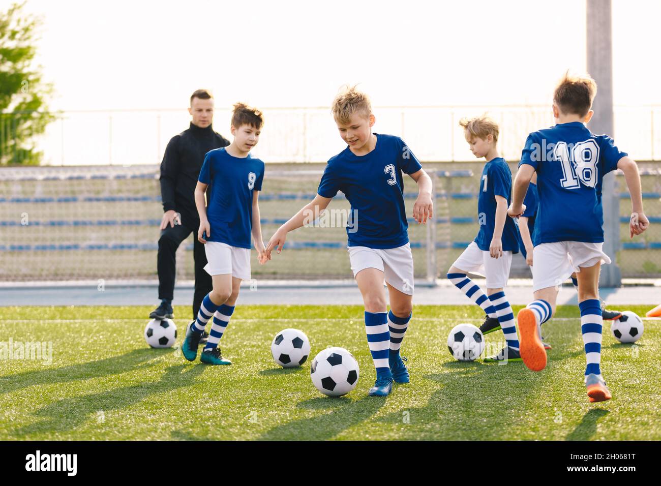 Group of Friends Training Football with Young Coach. School Boys ...