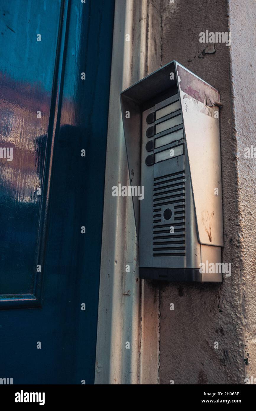 Building door intercom next to a blue door Stock Photo - Alamy