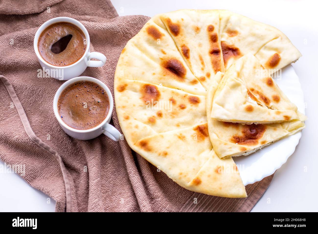 Homemade freshly baked flat bread stuffed with cottage cheese on a ...