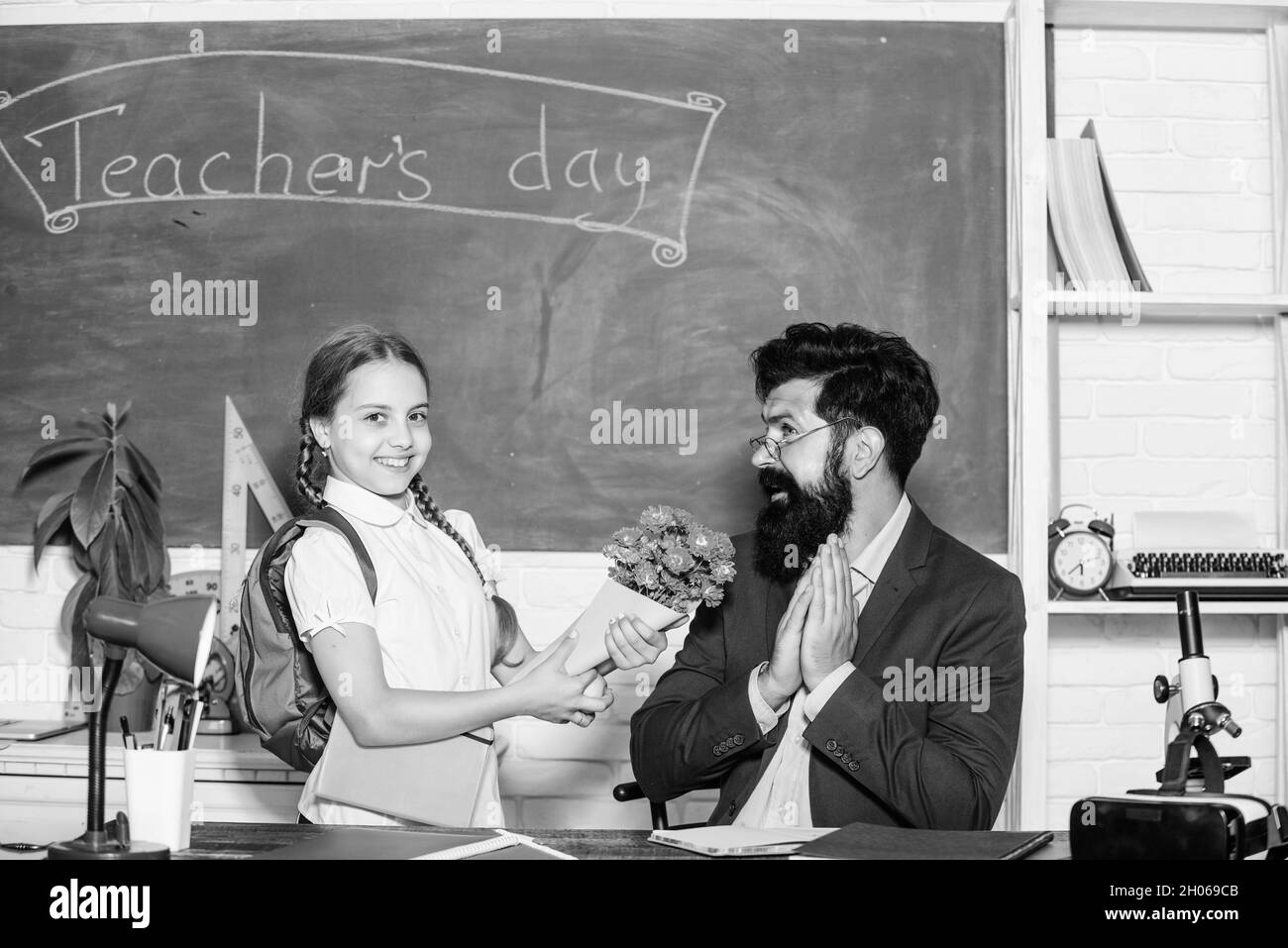 Back to school. Best wishes. Girl adorable pupil with backpack giving ...