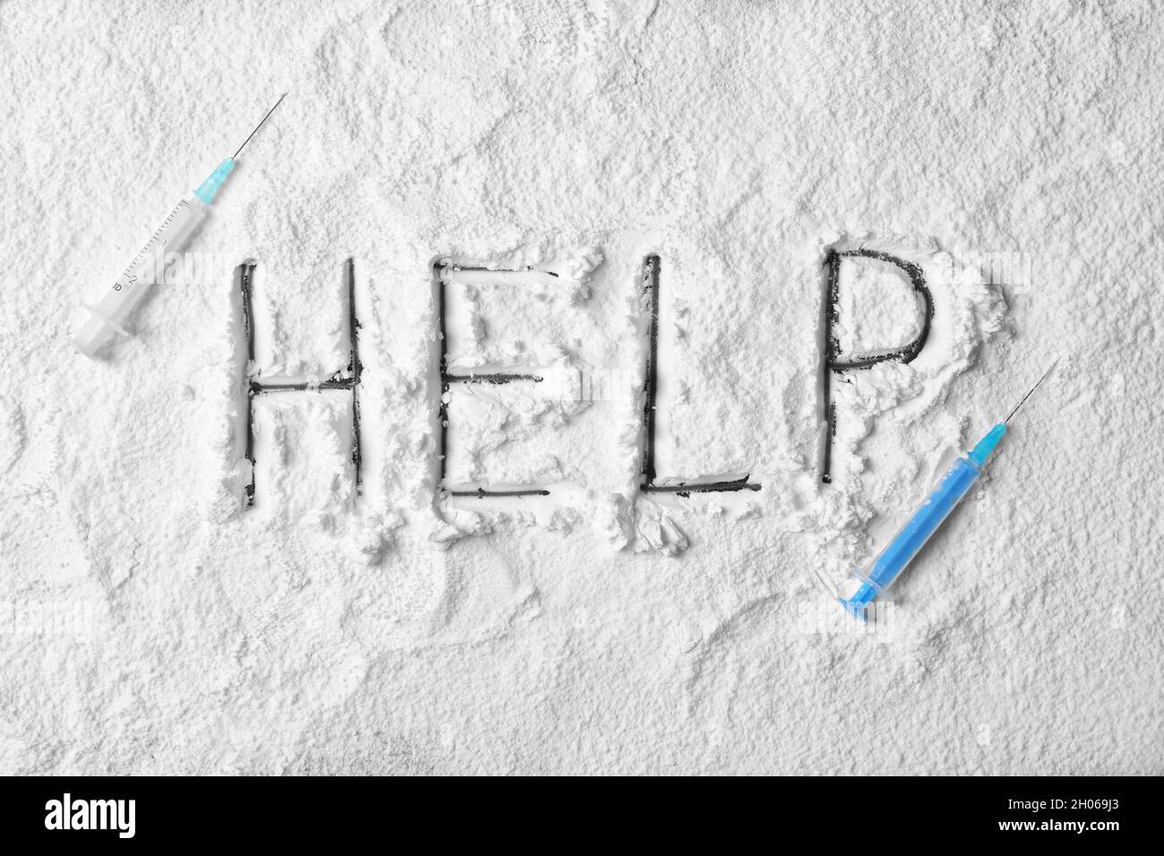 Syringes on cocaine powder with written word Help, top view Stock Photo ...
