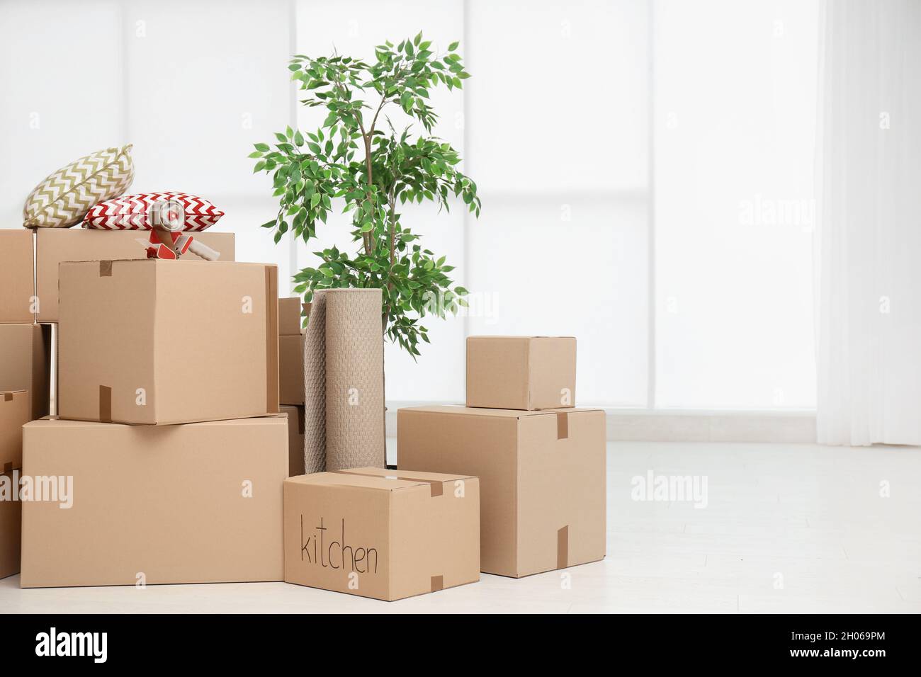 Pile of moving boxes in empty room Stock Photo - Alamy