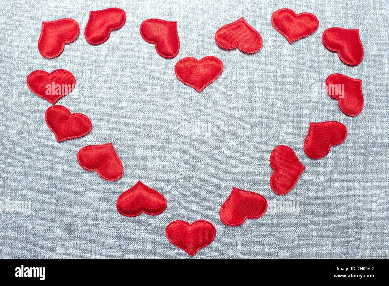 red hearts laid out in the shape of a big heart on a silver background ...