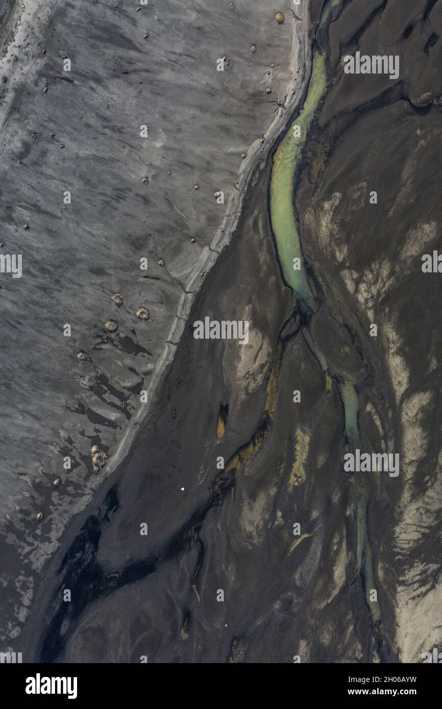 Aerial view of patterns of Icelandic rivers flowing into the ocean ...