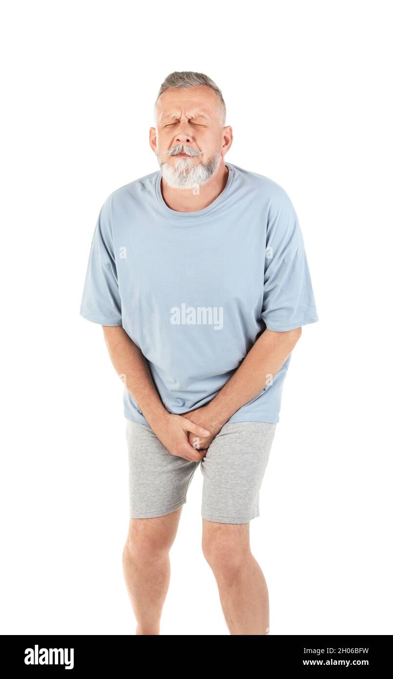 Mature man with urological problems suffering from pain on white ...