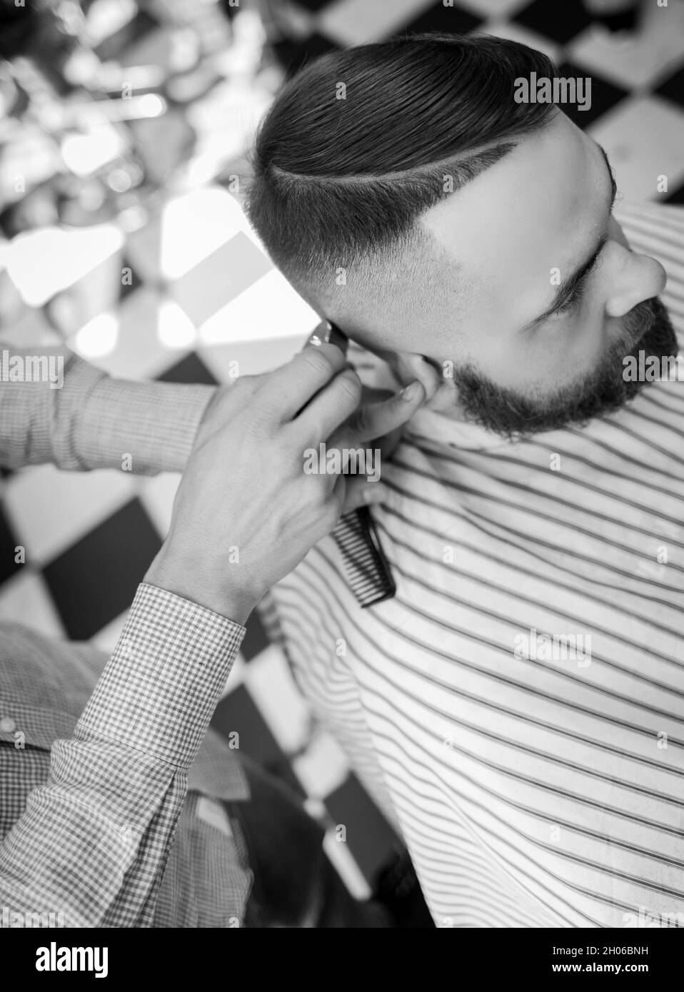 Hairdresser making haircut man Black and White Stock Photos & Images ...