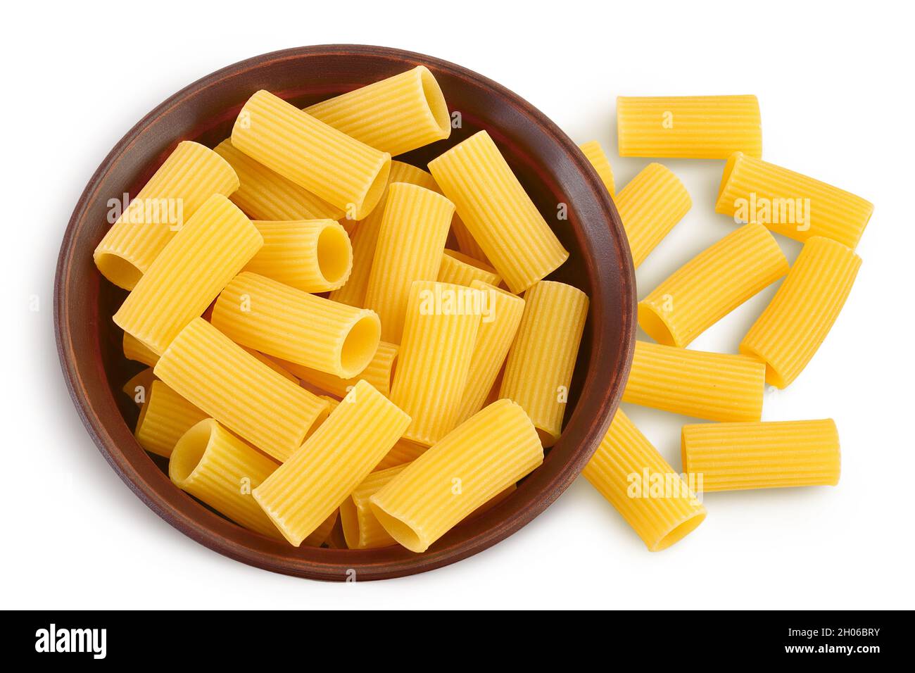 raw italian Rigatoni pasta in ceramic bowl isolated on white background ...