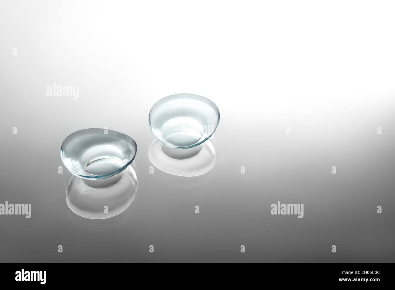 Contact lenses on glass background Stock Photo - Alamy