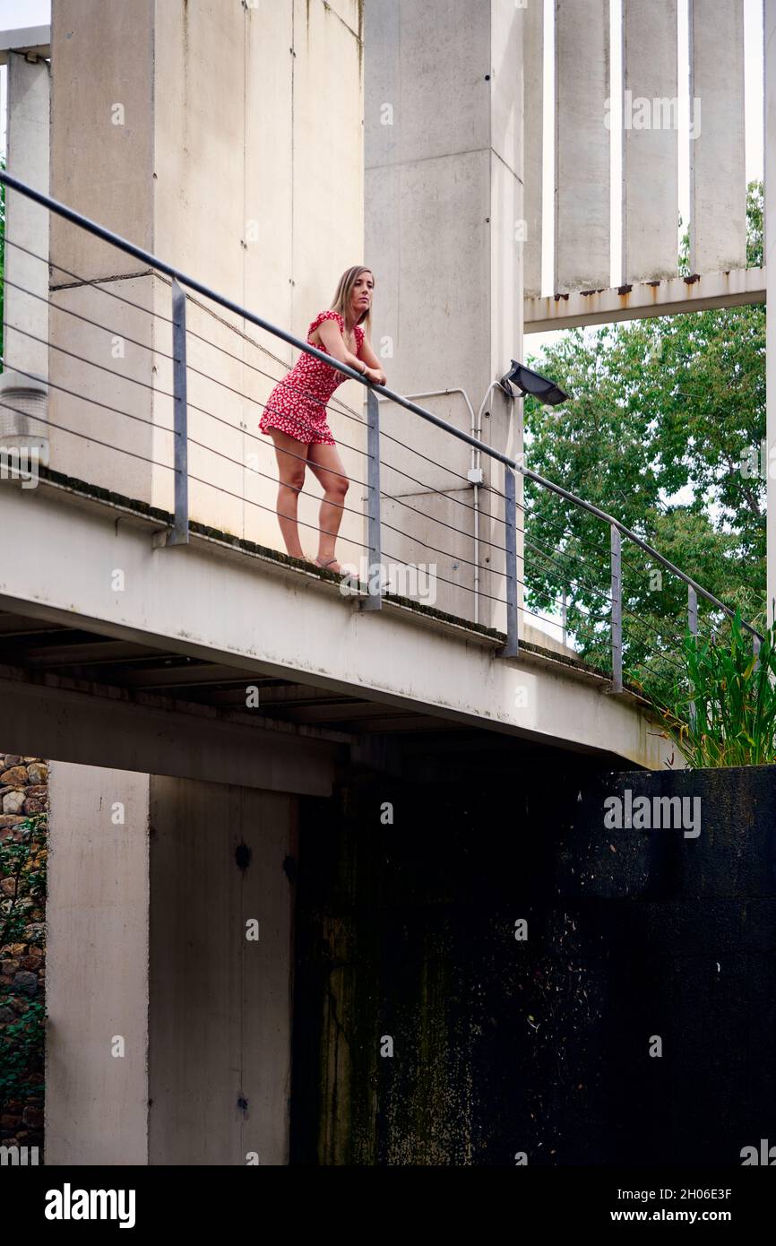 Vertical shot of a Spanish female standing on the balcony Stock Photo ...