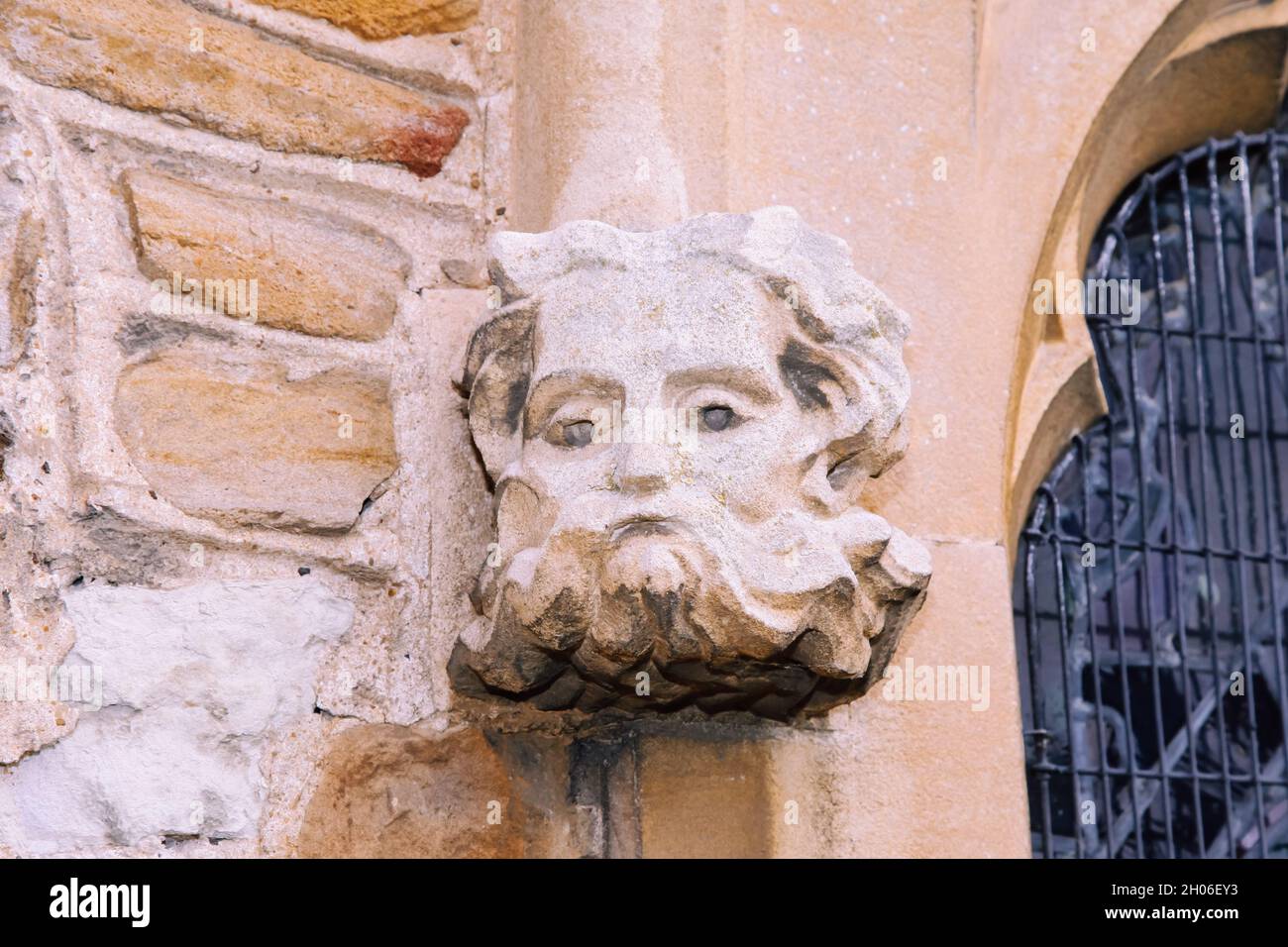 Mediaeval figure stone head on the hood mould of the window of Frensham ...