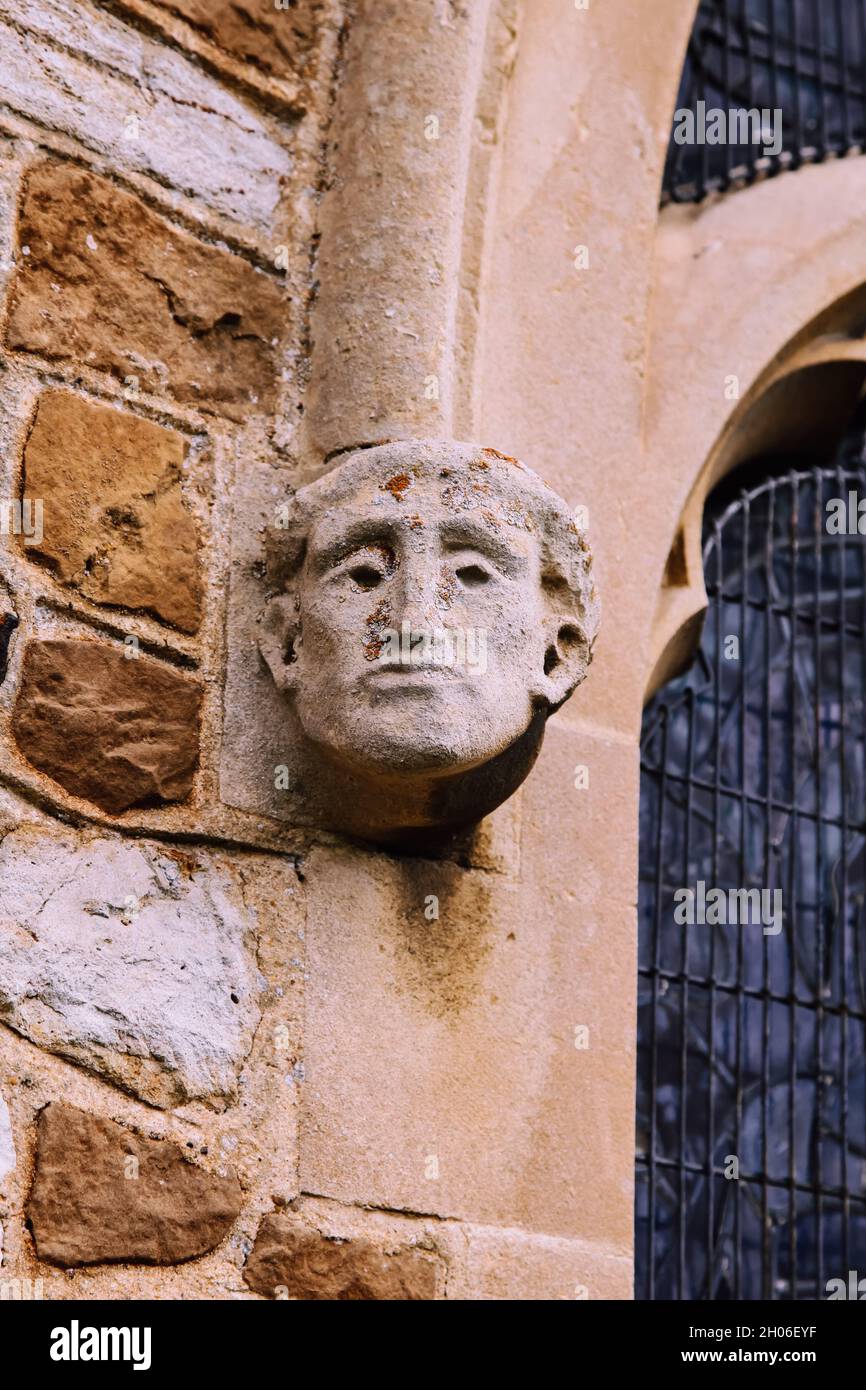Mediaeval figure stone head on the hood mould of the window of Frensham ...