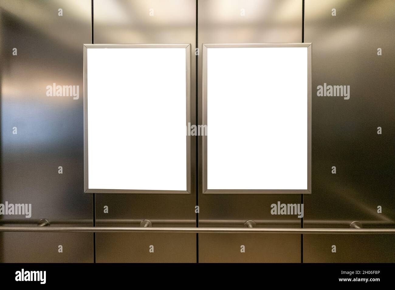 Mock up. Two vertical poster media template frame hanging on the wall ...