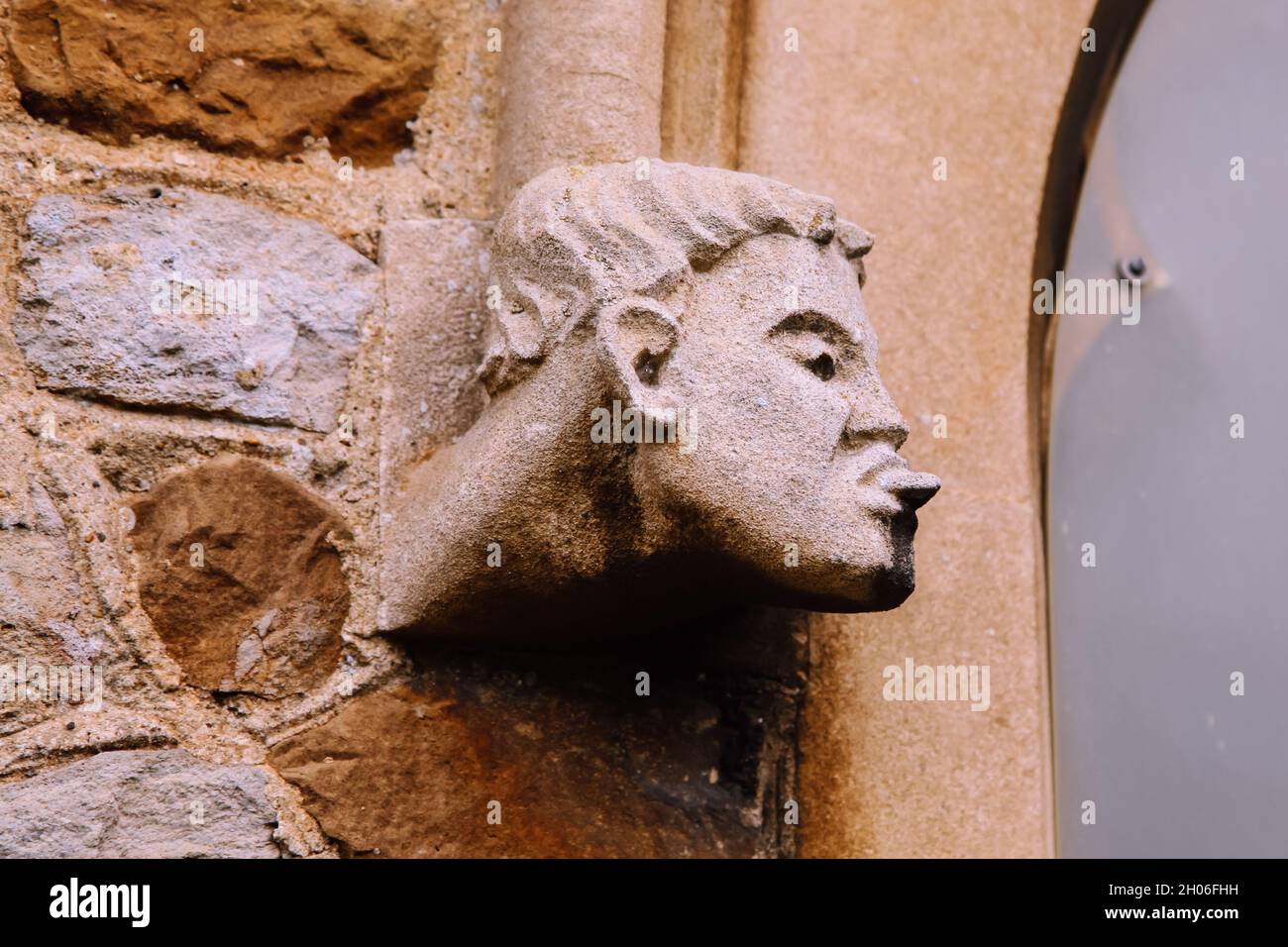 Mediaeval figure stone head on the hood mould of the window of Frensham ...