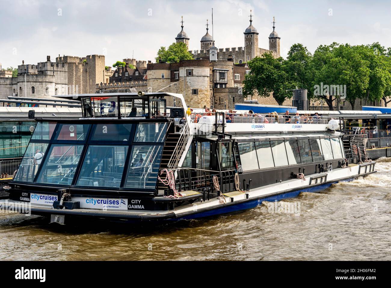 A City Cruises River Tour Boat With The Tower Of London In The ...