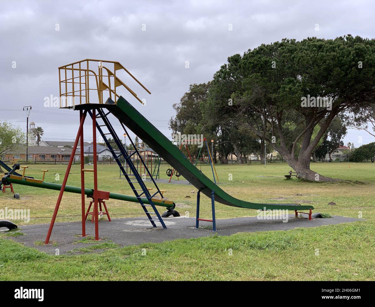Playground with pine tree Stock Photo - Alamy