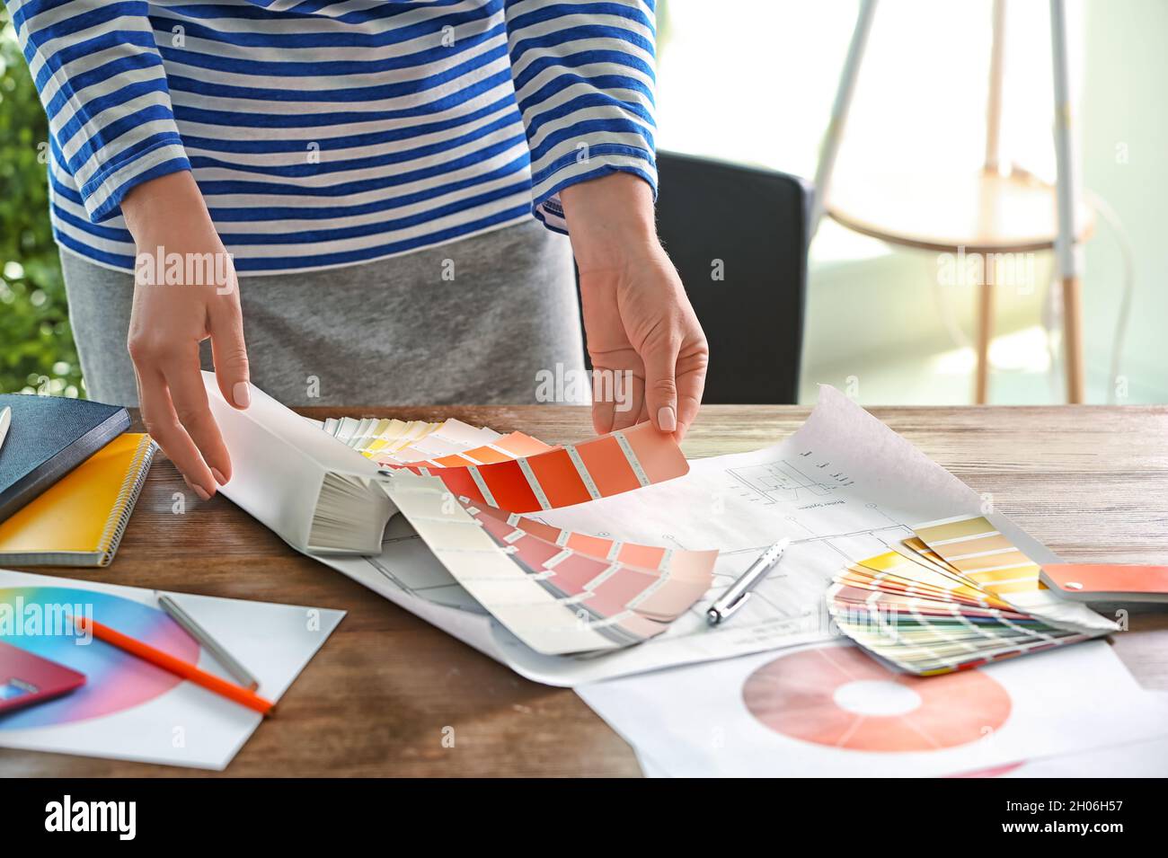 Female designer working with color palette samples at table Stock Photo ...