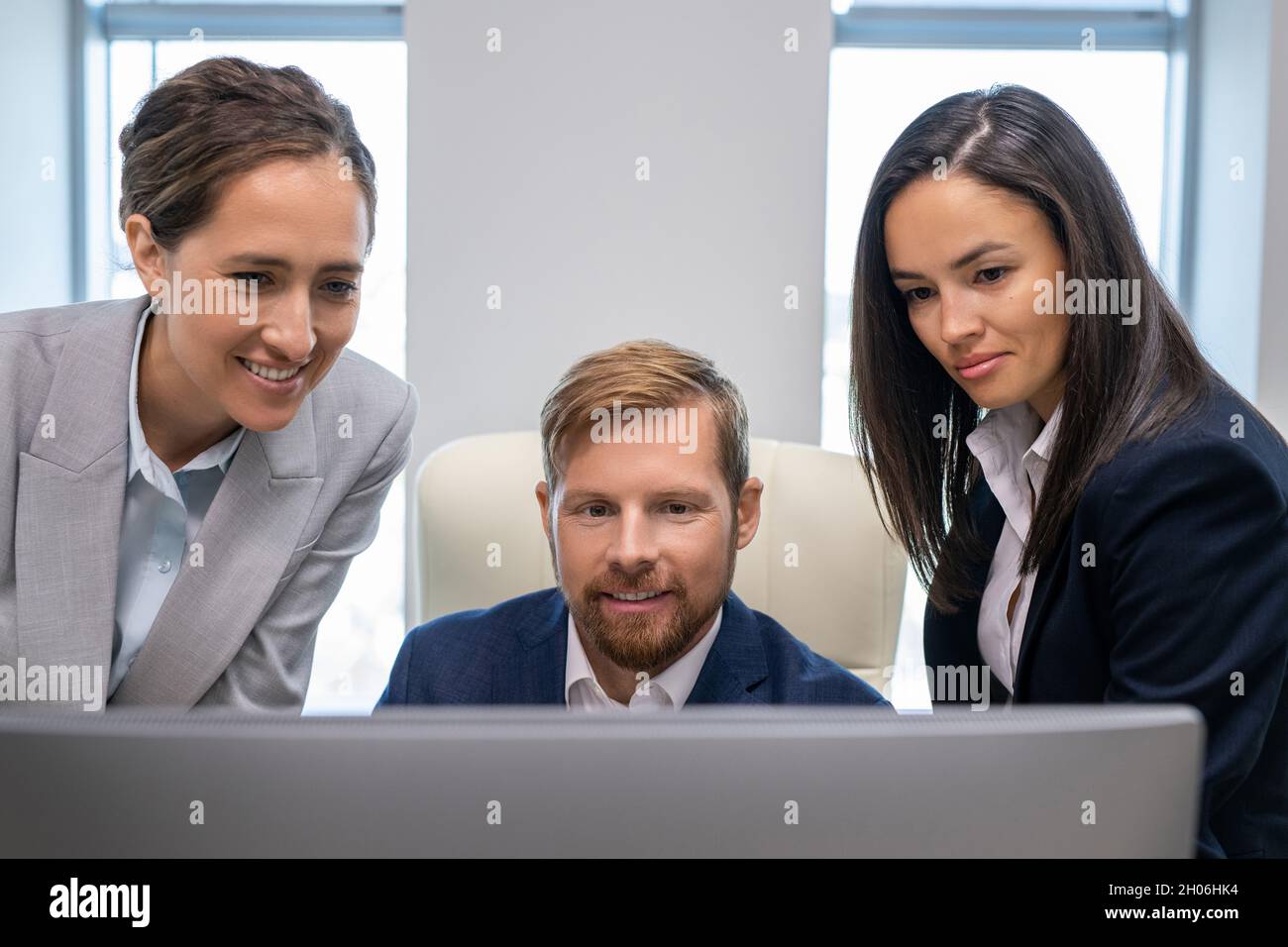 Group young people looking at computer hi-res stock photography and ...