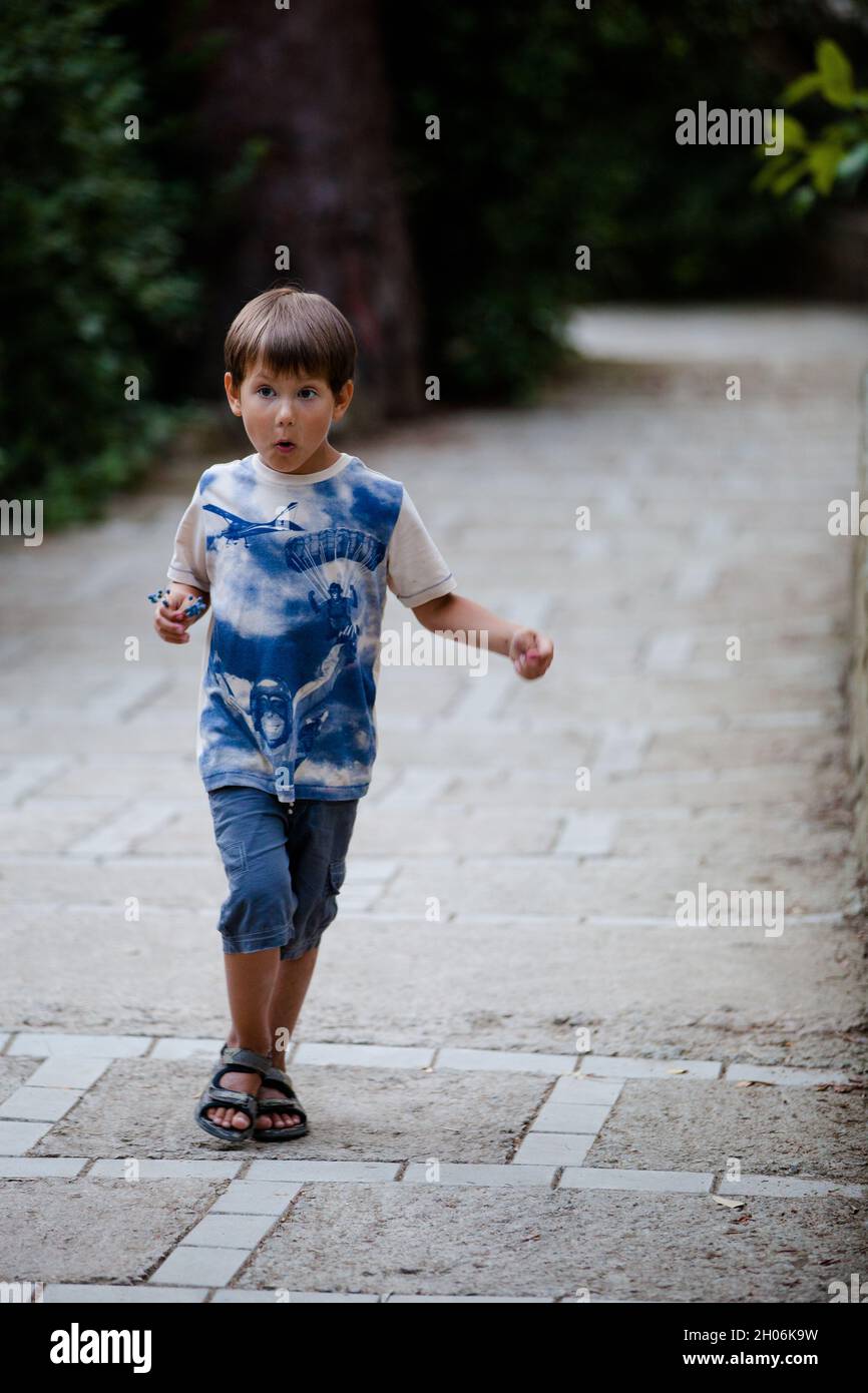 surprised child looks closely but does not run away Stock Photo - Alamy