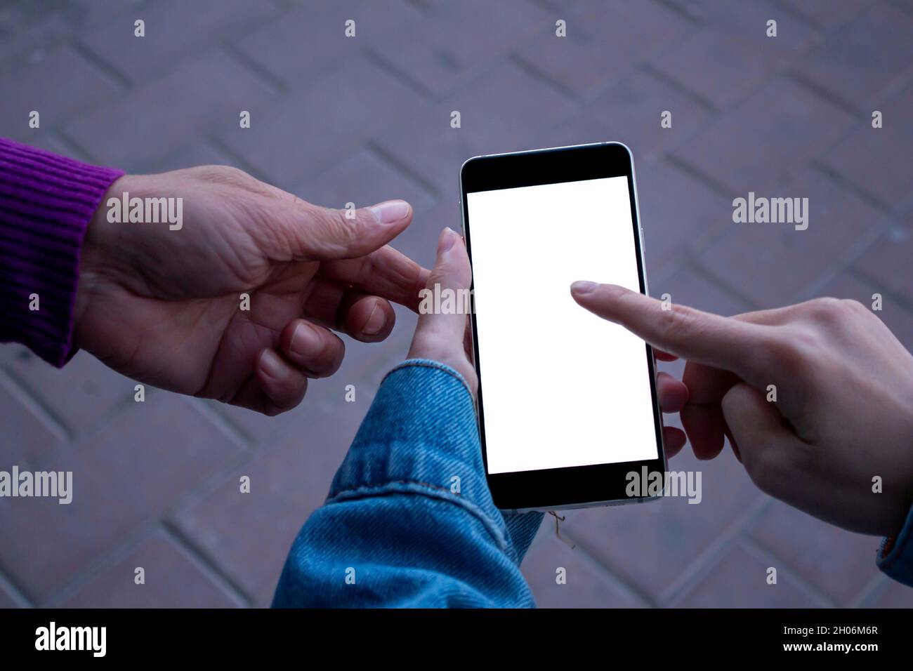Woman showing something on her smartphone to her friend. Mockup image ...