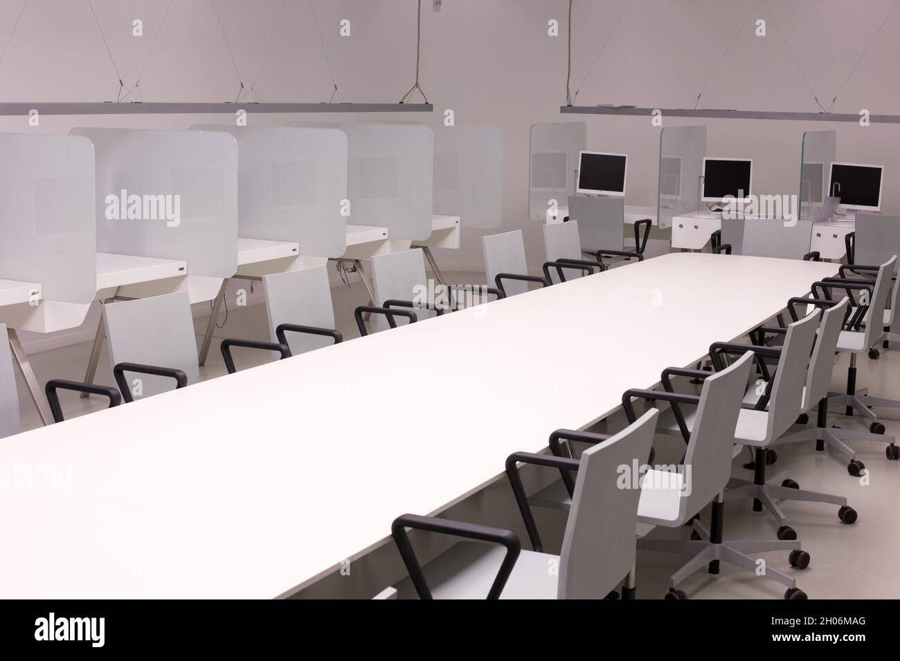 Modern computer lab with white furniture and suspended lighting Stock ...