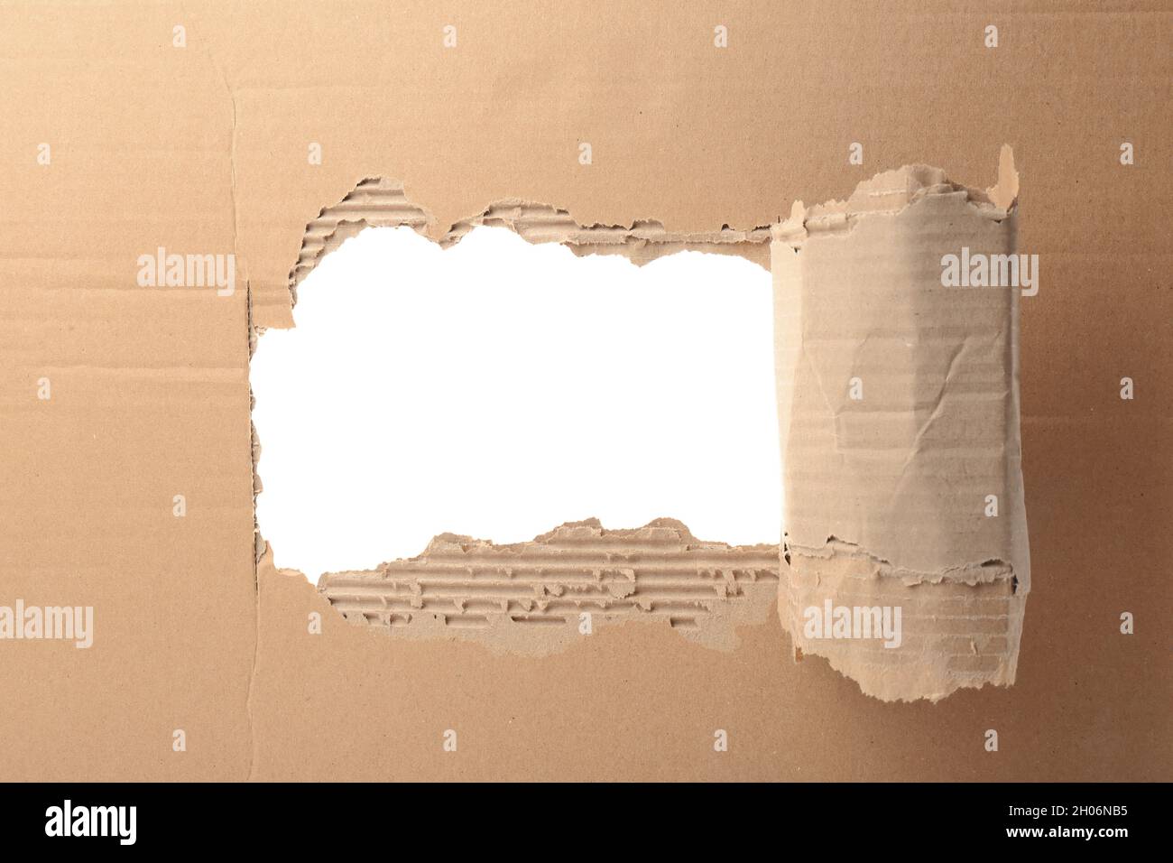 Hole in cardboard on white background. Recyclable material Stock Photo ...