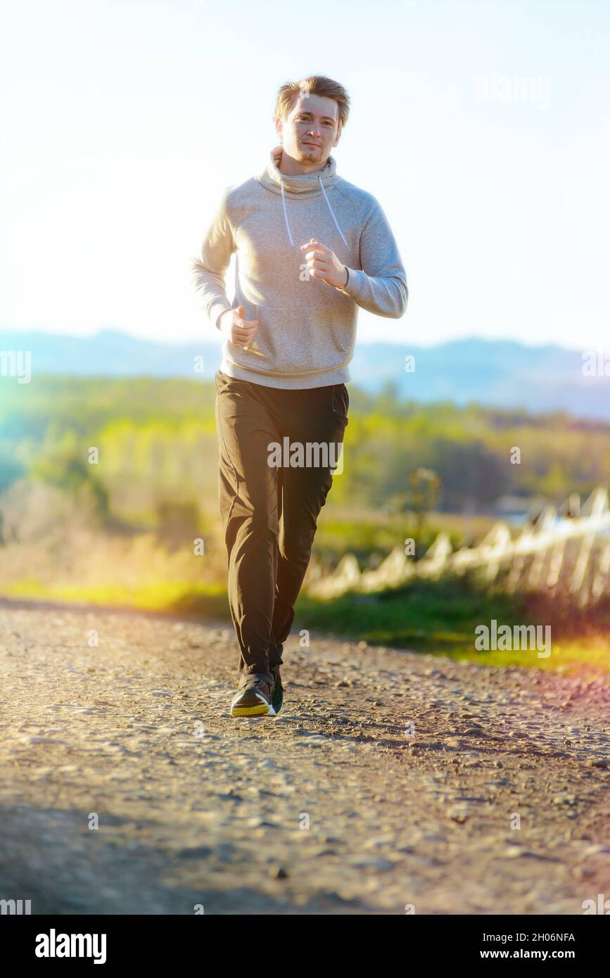 Running man jogging in rural nature at beautiful summer day. Sport ...