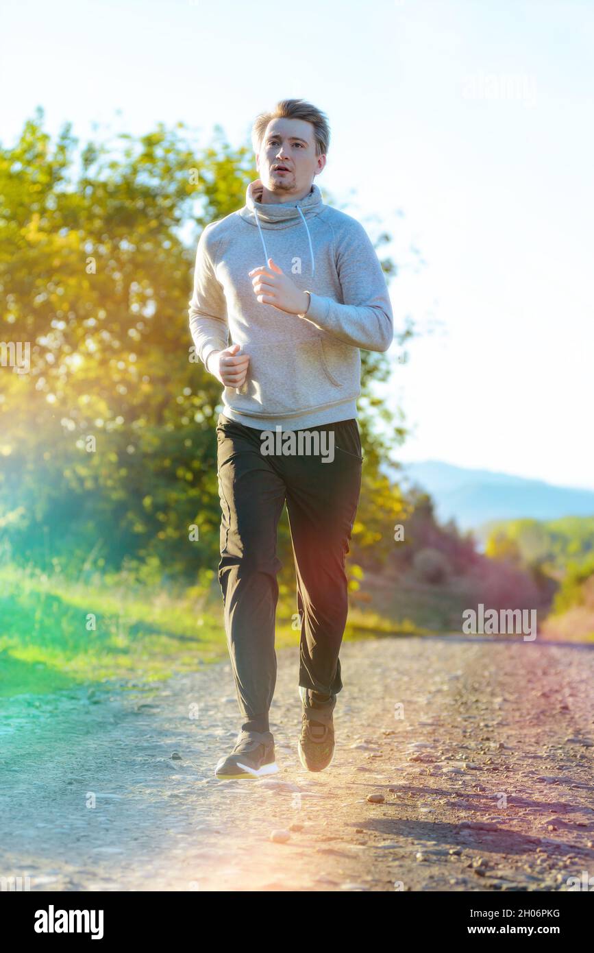 Running man jogging in rural nature at beautiful summer day. Sport ...