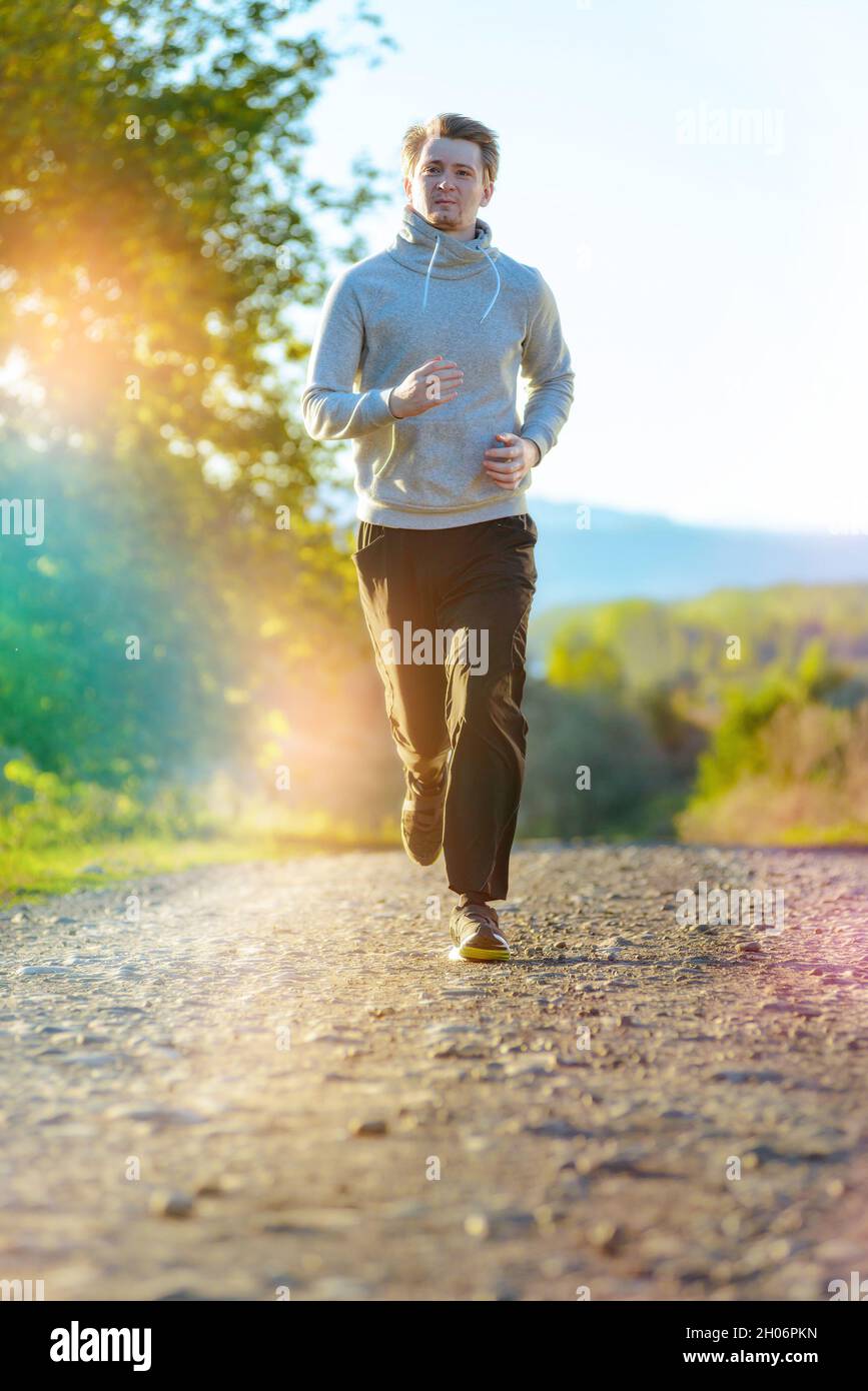 Running man jogging in rural nature at beautiful summer day. Sport ...
