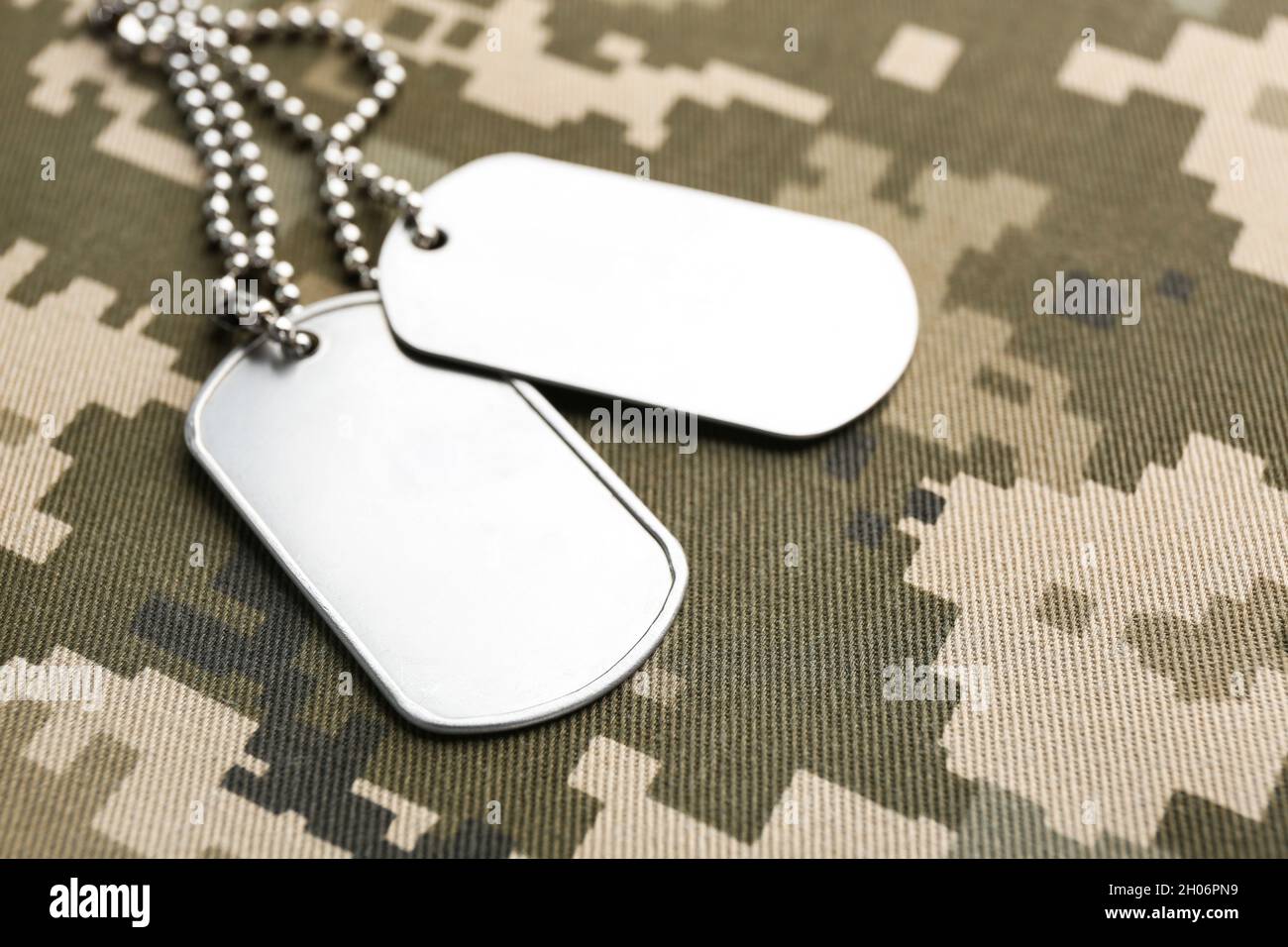 Military ID tags on camouflage background Stock Photo - Alamy