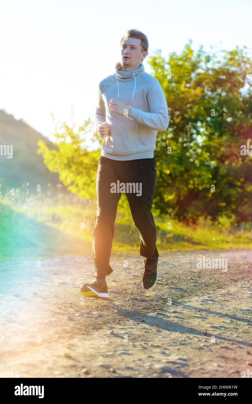 Running man jogging in rural nature at beautiful summer day. Sport ...