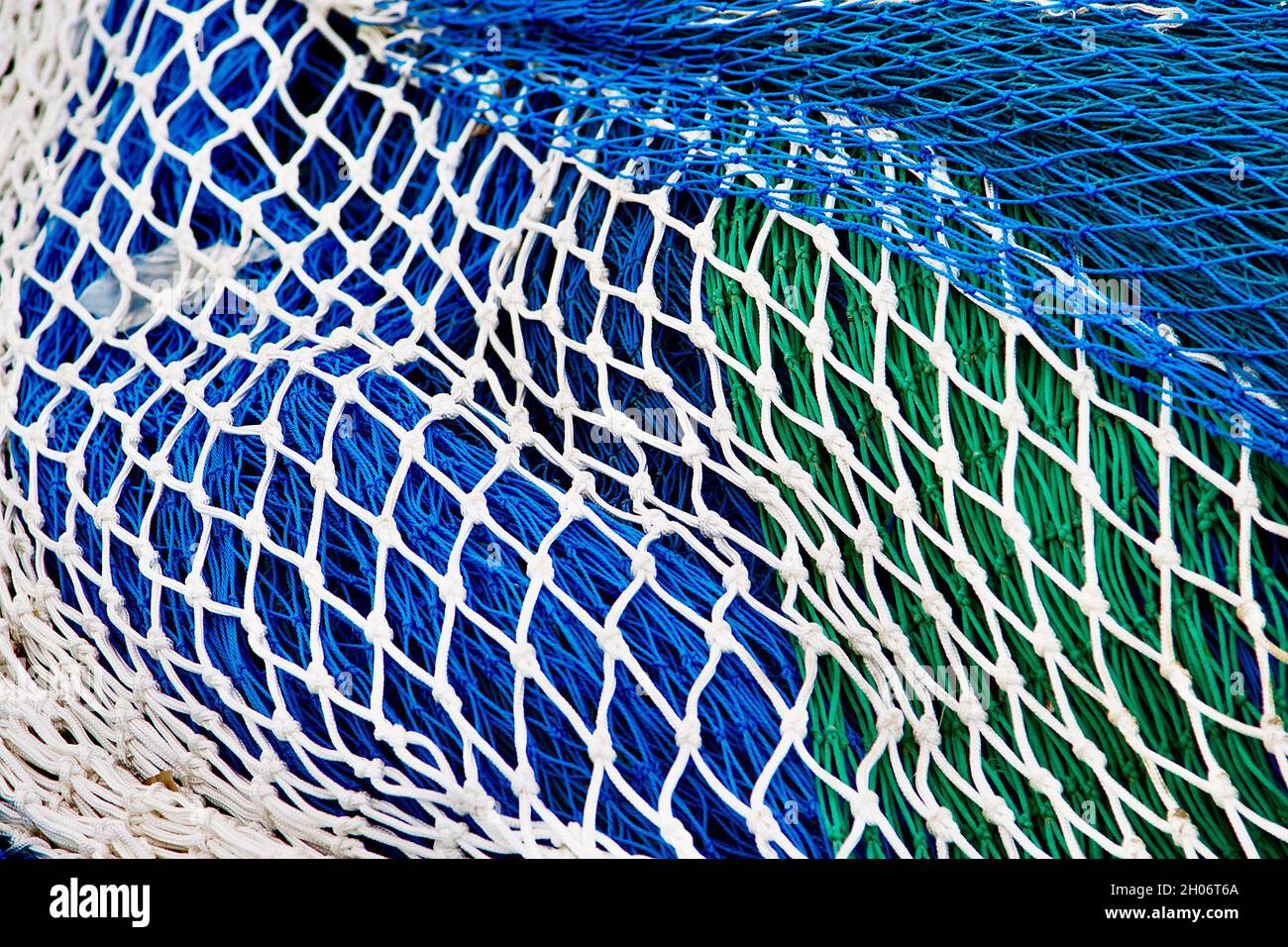 Green, white and blue coloured fishing nets Stock Photo - Alamy