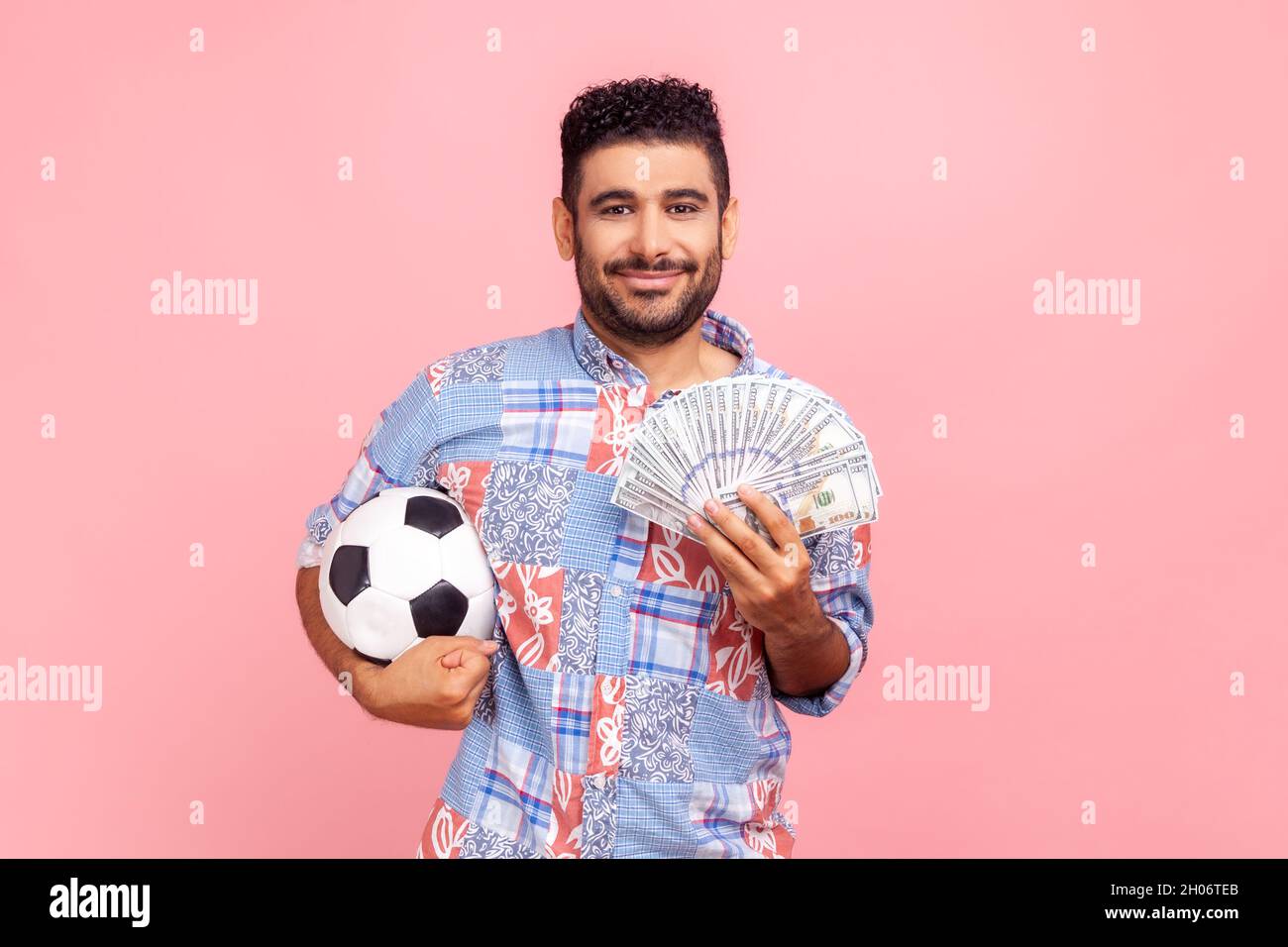 Happy smiling man holding showing soccer ball and fun of hundred dollar ...
