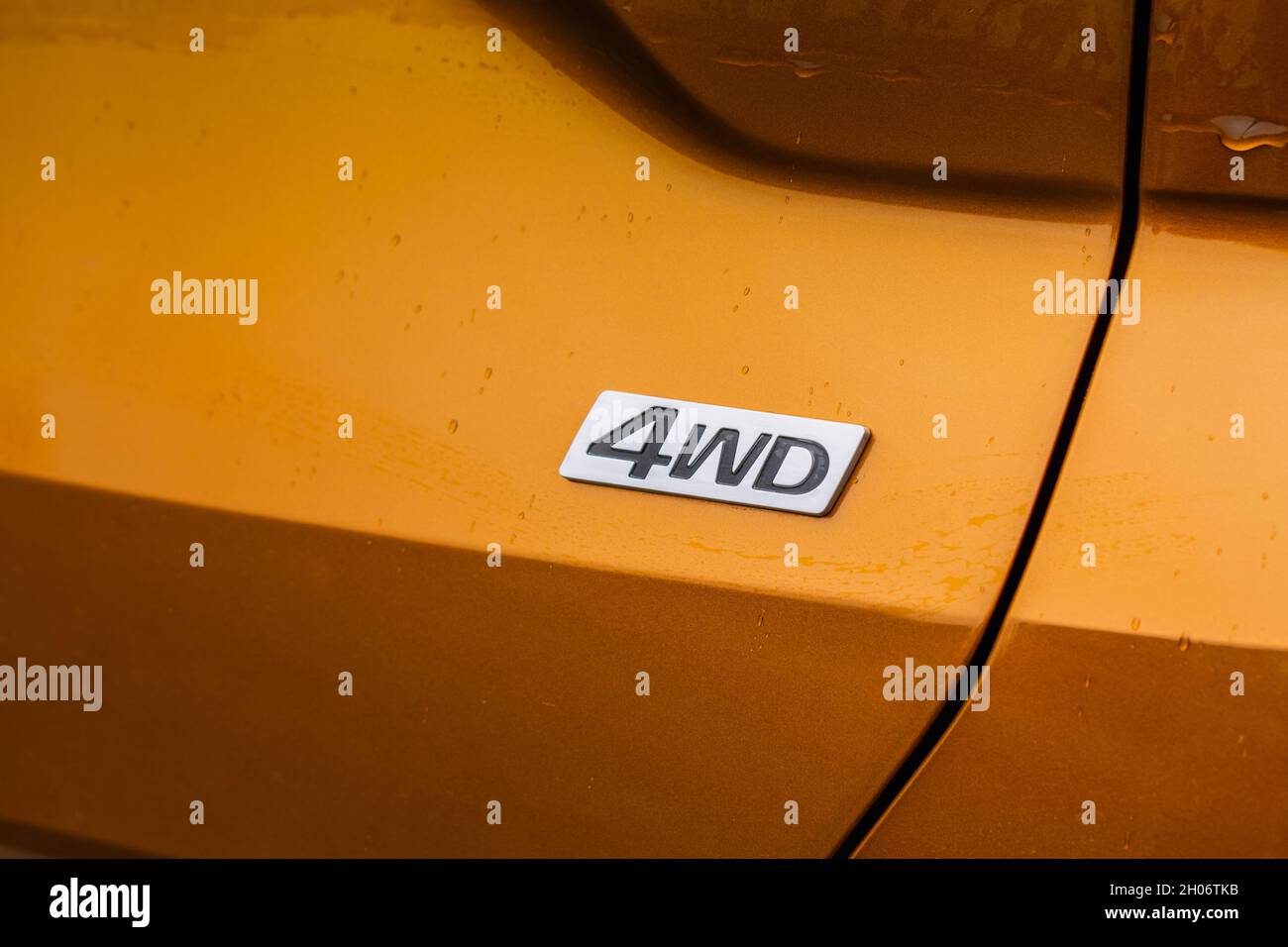 AWD emblem on modern orange SUV car detail close up view. All Wheel ...