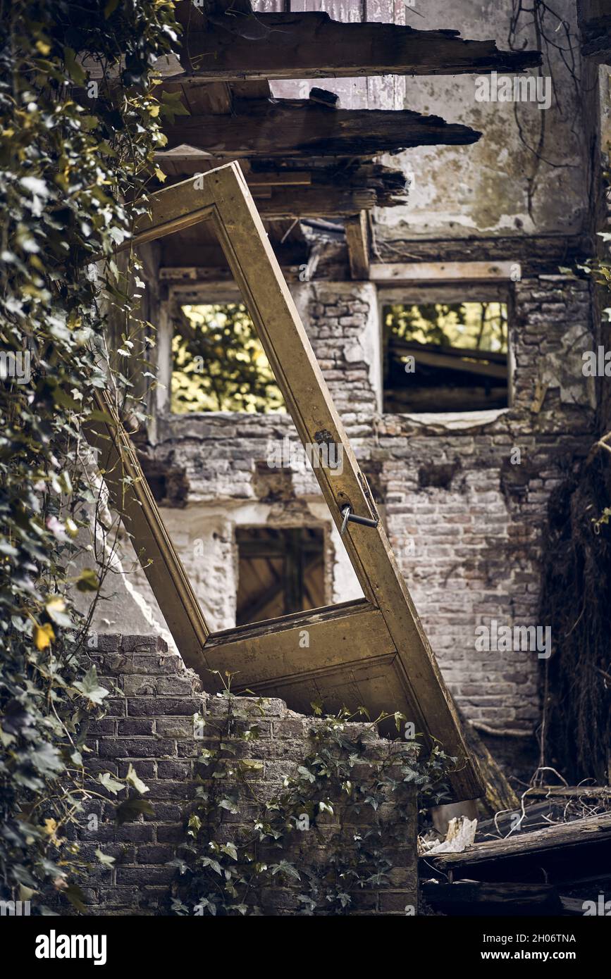 Vertical shot of a broken door frame and house ruins Stock Photo - Alamy