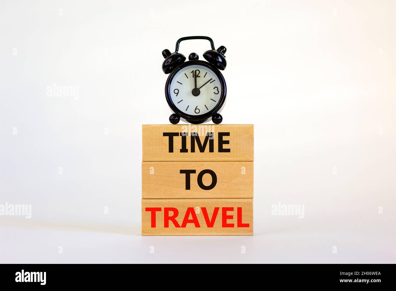 Time to travel symbol. Wooden blocks with concept words 'Time to travel ...