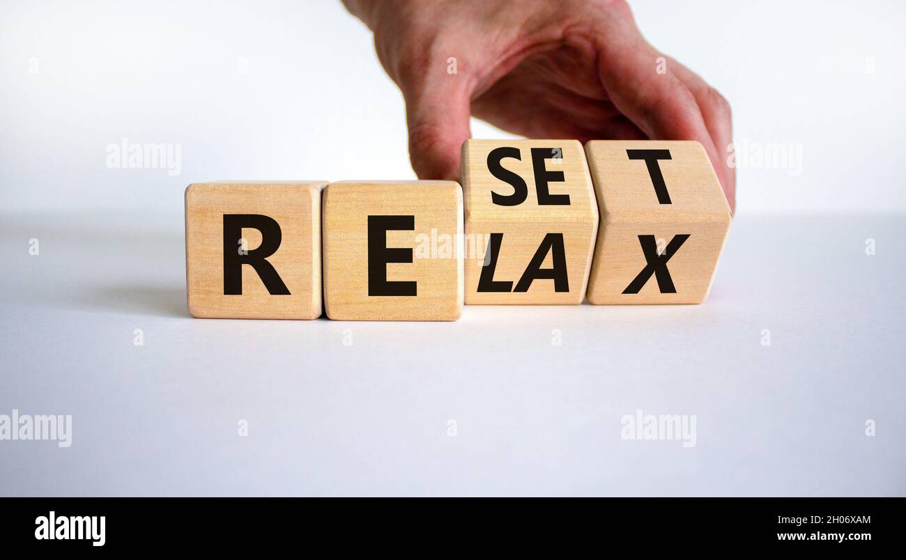 Relax and reset symbol. Businessman turns cubes and changes the word ...