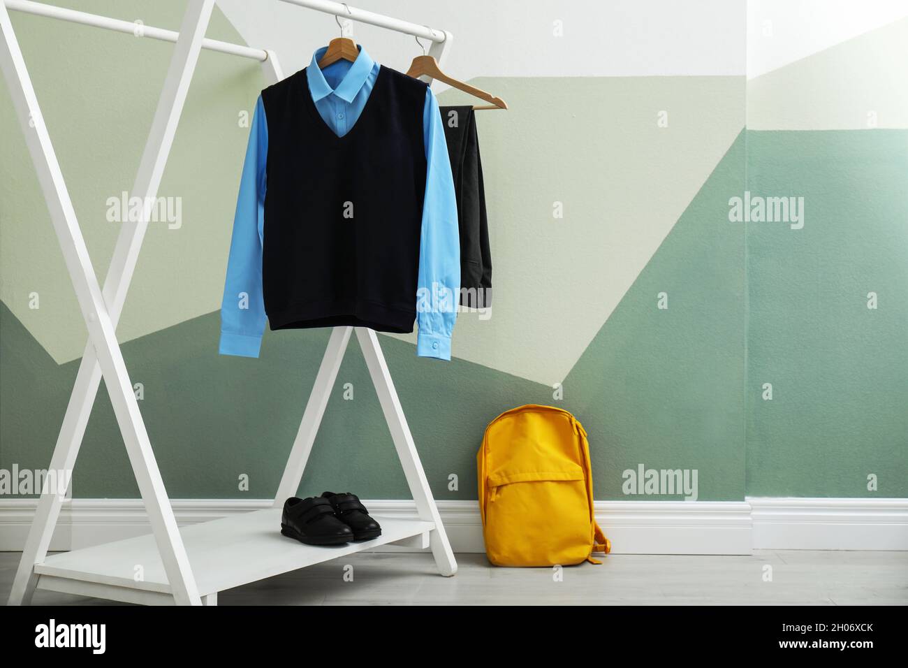 School uniform for boy on rack near color wall Stock Photo - Alamy