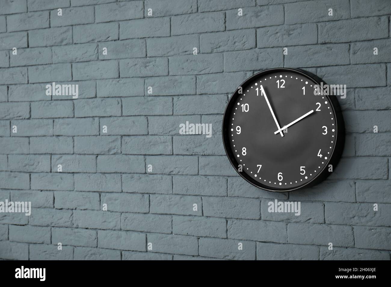 Modern clock on brick wall. Time concept Stock Photo - Alamy