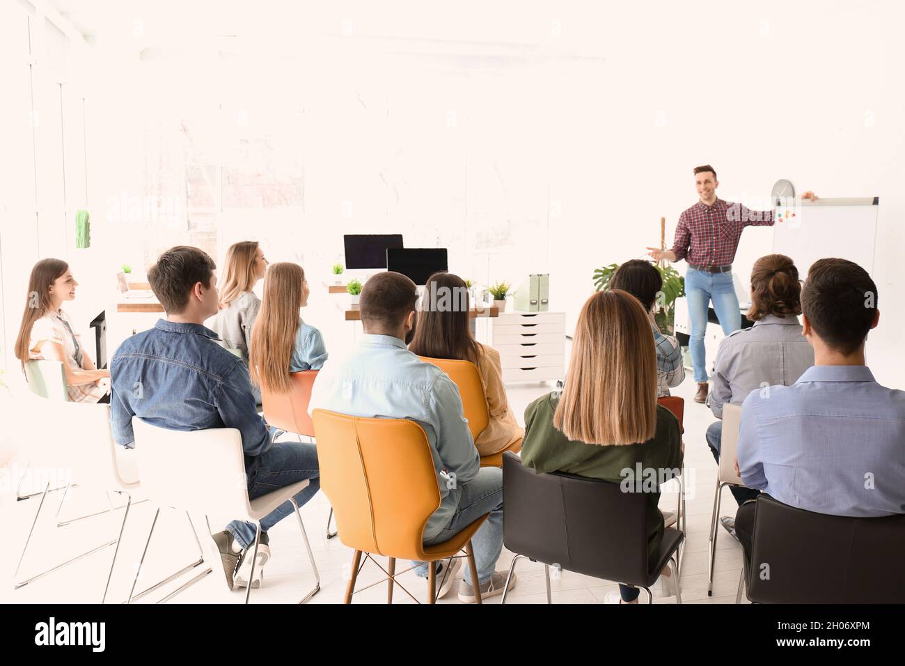 Male business trainer giving lecture in office Stock Photo - Alamy