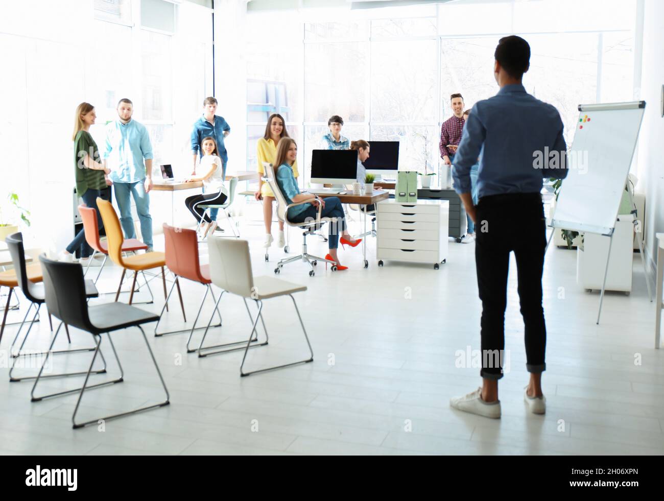 Male business trainer giving lecture in office Stock Photo - Alamy