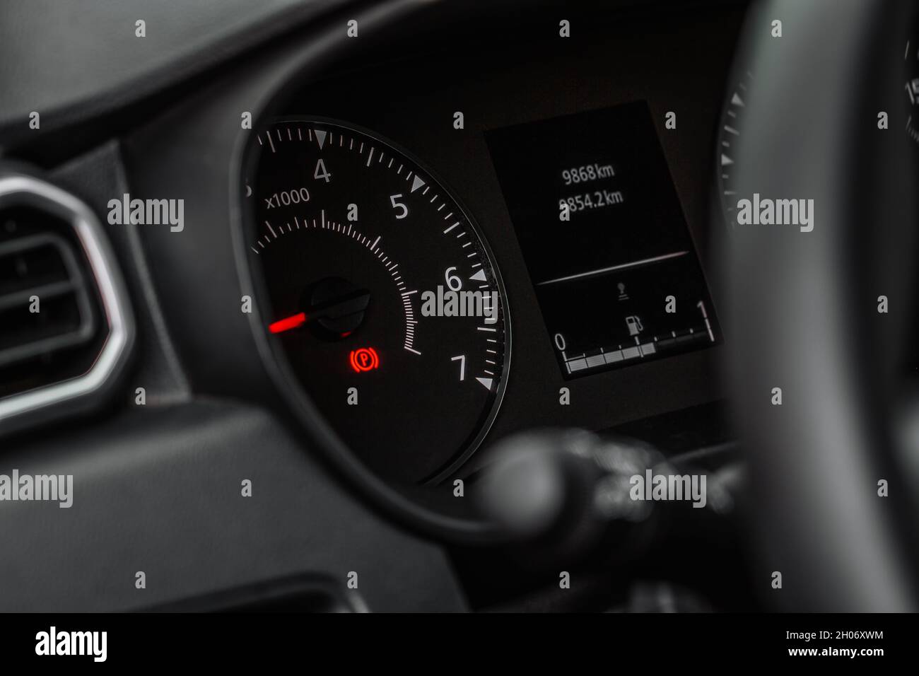 Modern car tachometer and dashboard with backlight. Close up shot of a ...
