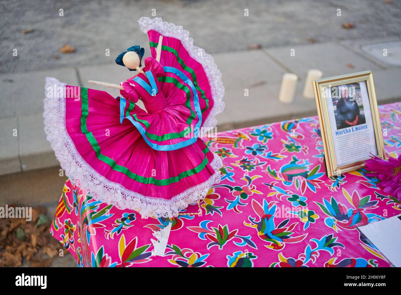 Day of the Dead folkloric dancer figurine next to a woman's memorial ...