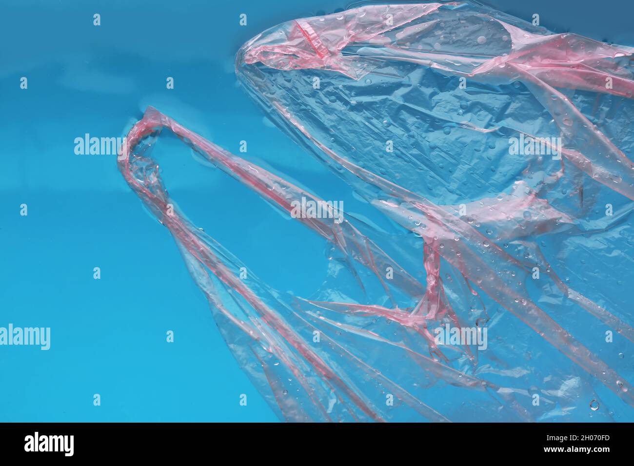 Plastic bag floating on water surface, top view. Ocean pollution ...