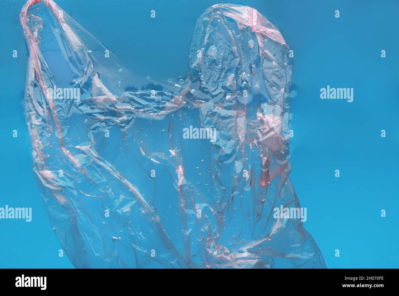 Plastic bag floating on water surface, top view. Ocean pollution ...